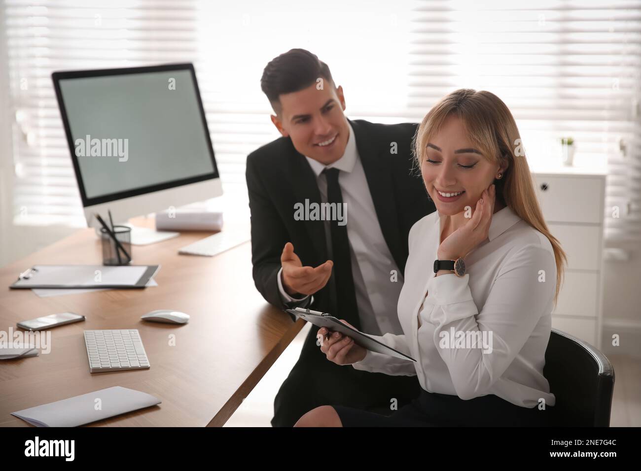 Man flirting with his colleague during work in office Stock Photo - Alamy