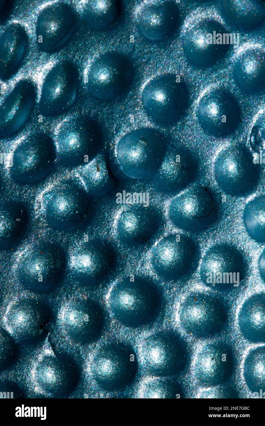 A Alien trypophobia holes in a shiny sci-fi close up background Stock ...