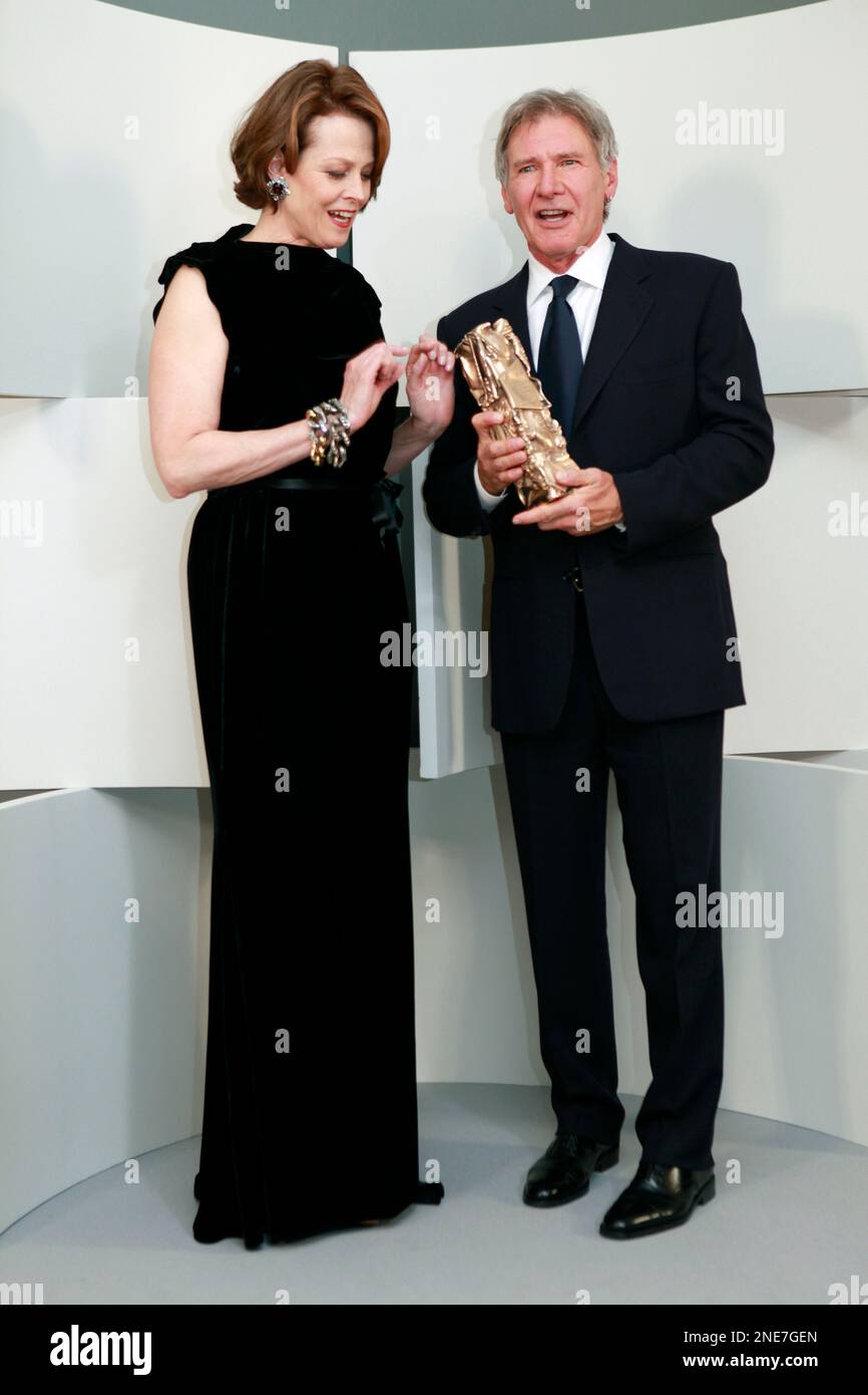 U.S actor Harrison Ford, right, display the Cesar of Honor award, as he ...