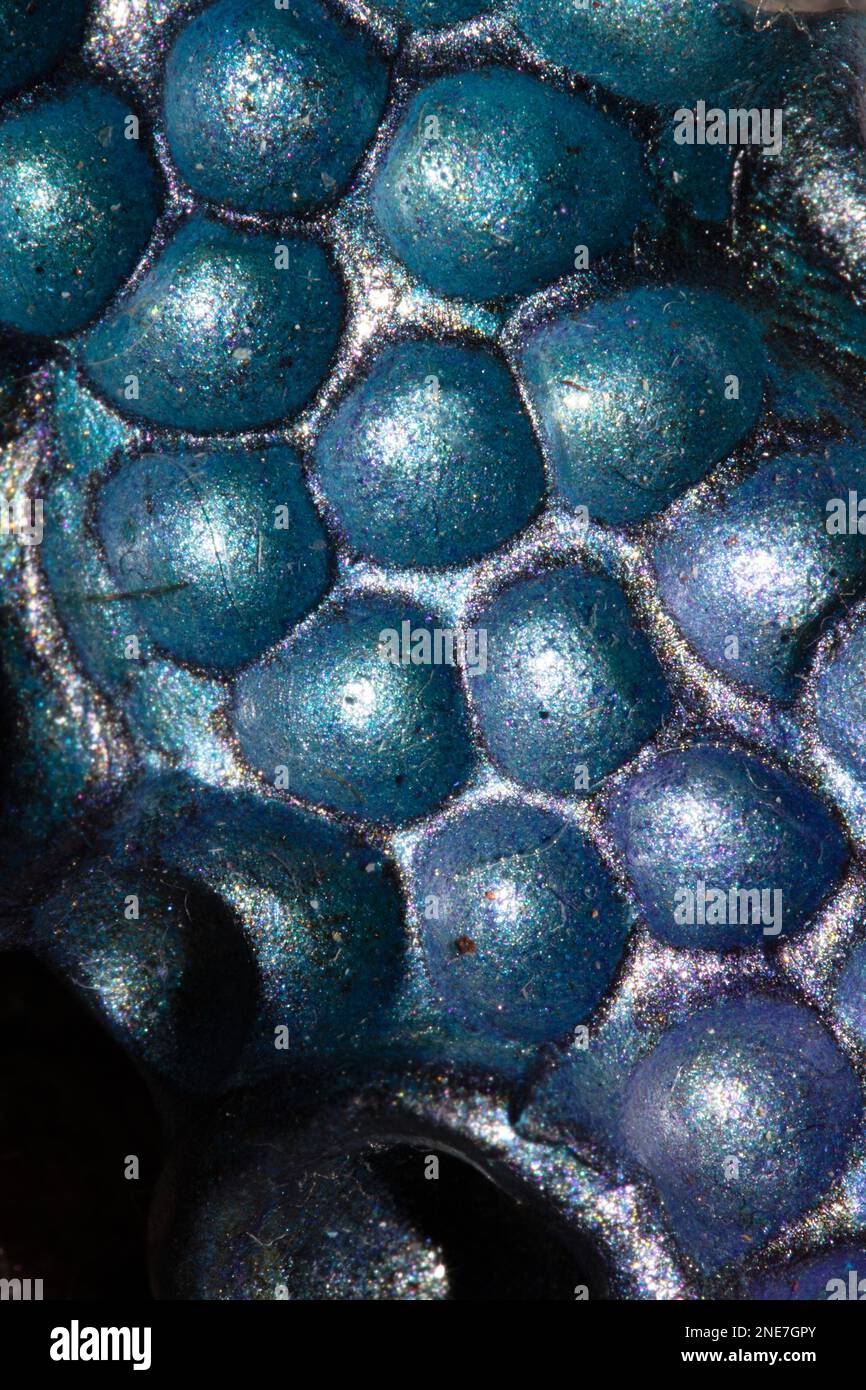 A Alien trypophobia holes in a shiny sci-fi close up background Stock ...