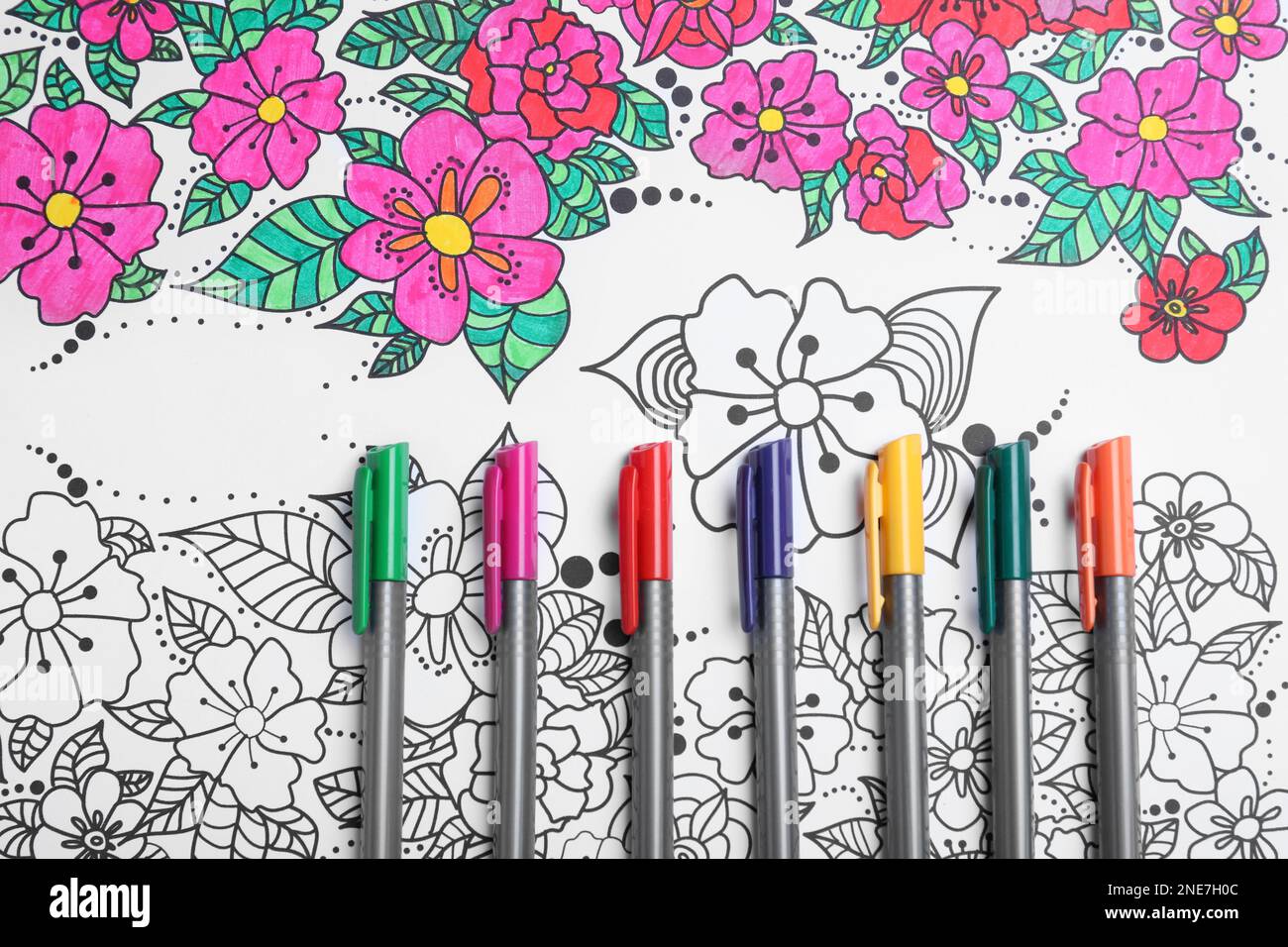 Felt tip pens on antistress coloring page, top view Stock Photo - Alamy