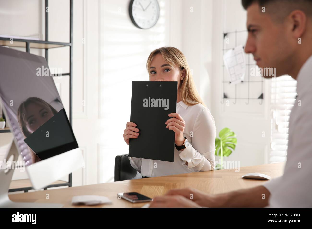 Young woman flirting with her colleague during work in office Stock ...
