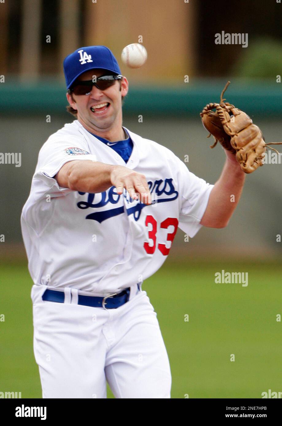 Los Angeles Dodgers third baseman Blake DeWitt throws to first during ...