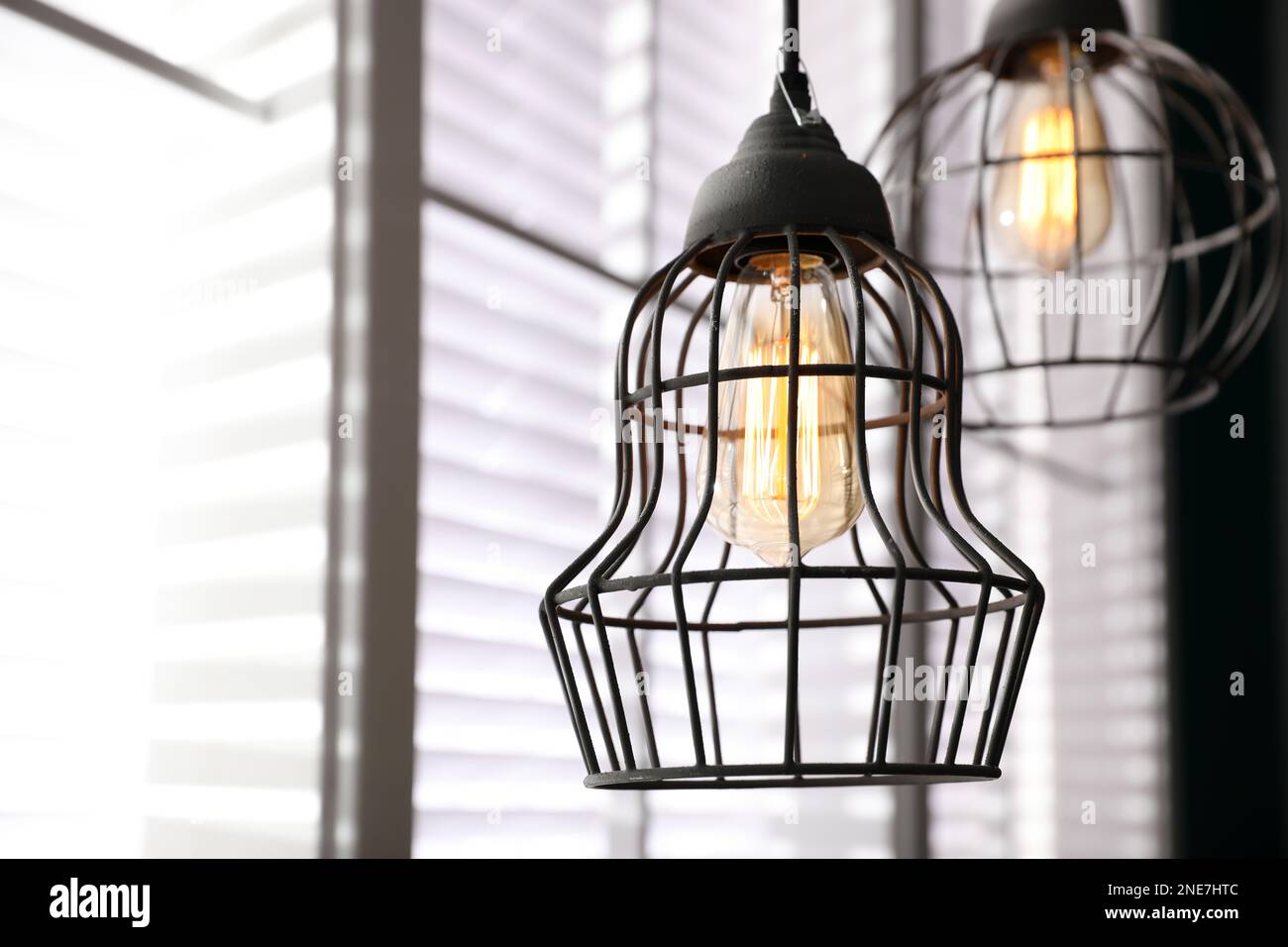 Stylish metallic pendant lamp with Edison light bulb indoors Stock ...
