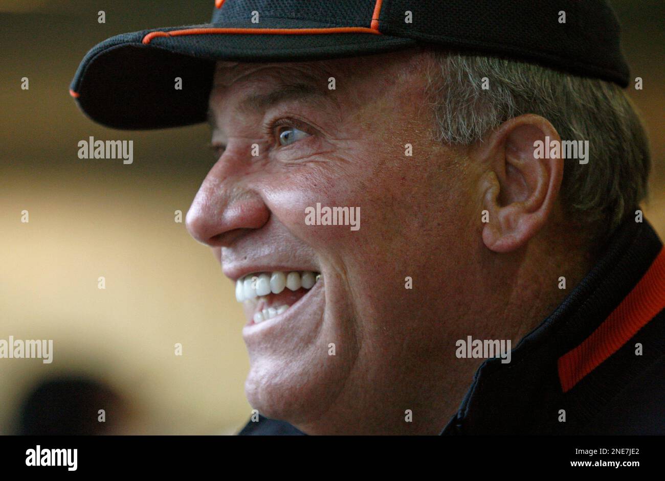 Baltimore Orioles manager Dave Trembley smiles inside the batting cages ...