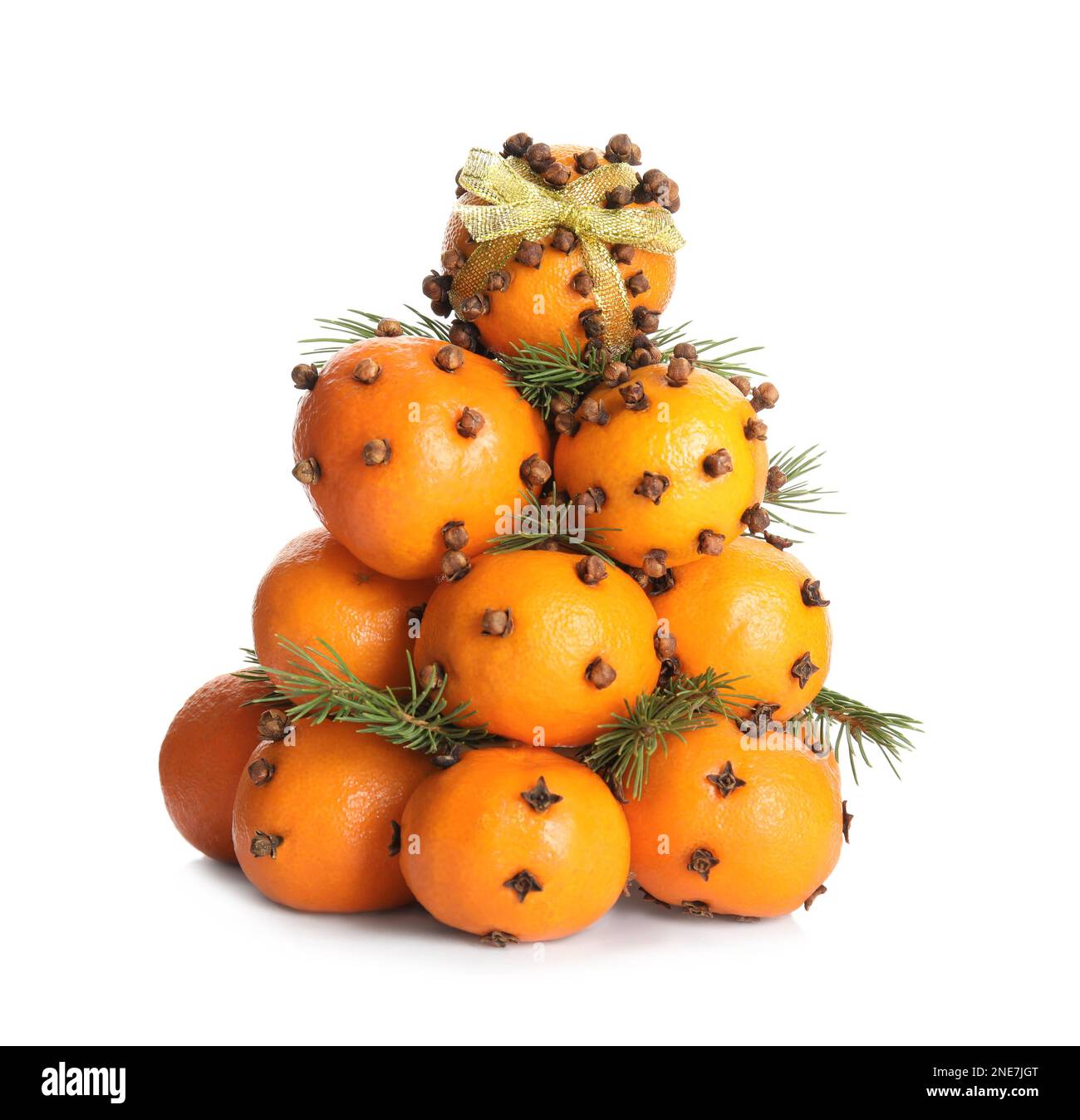 Pomander balls made of tangerines with cloves and fir branches on white ...