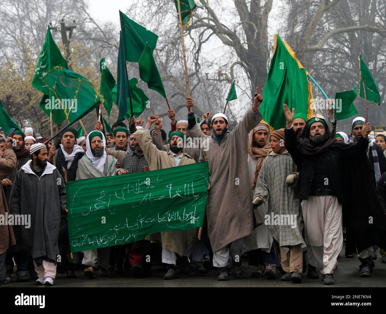 Kashmiri Muslims hold Islamic flags and banners as they shout Islamic ...