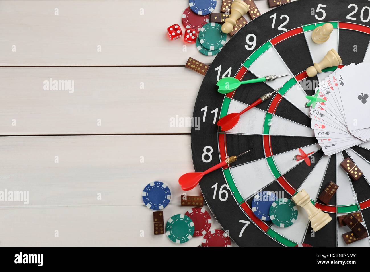 Elements of different board games on white wooden table, flat lay ...