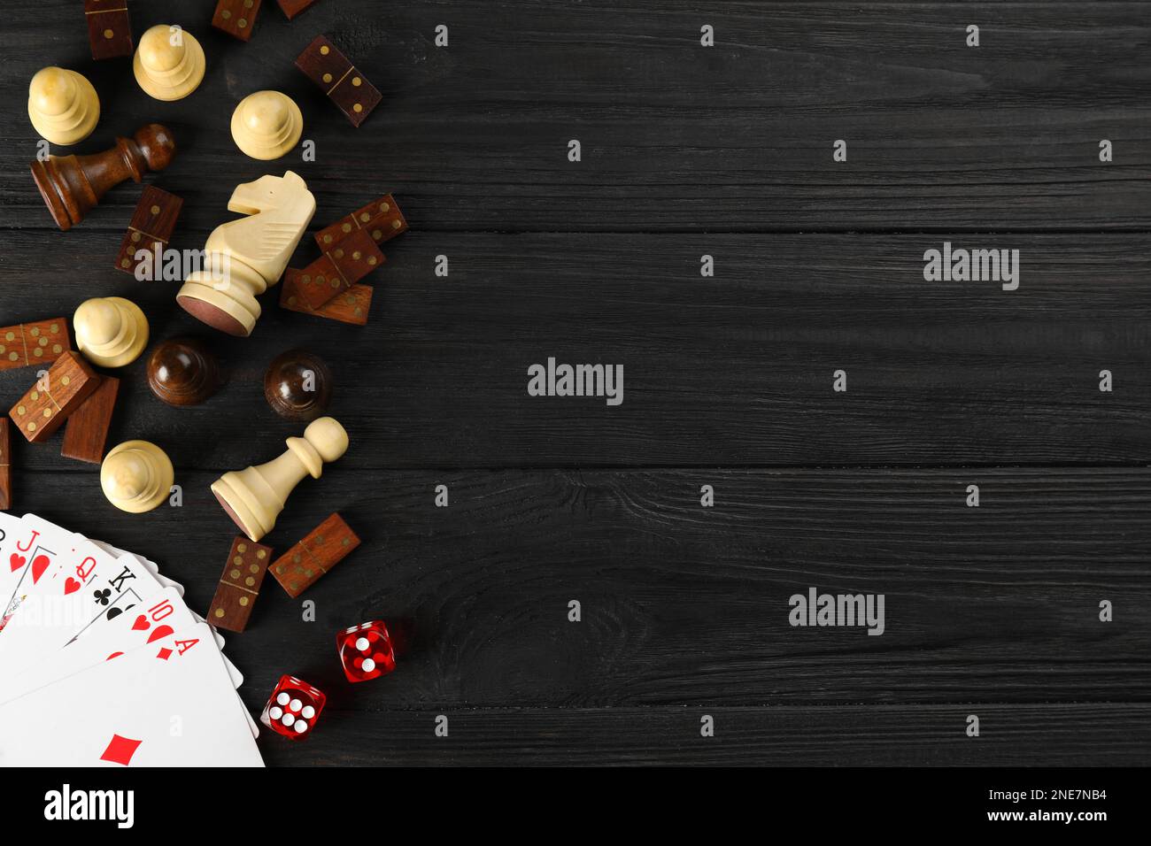 Elements of different board games on dark wooden table, flat lay. Space ...