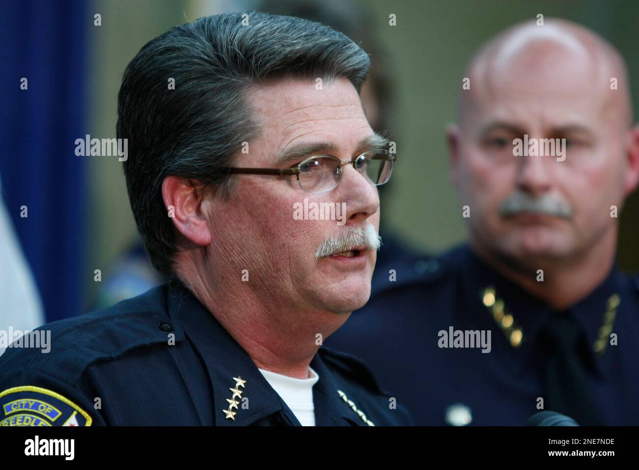 Reedley police chief Steve Wright, left, speaks as Fresno police chief ...