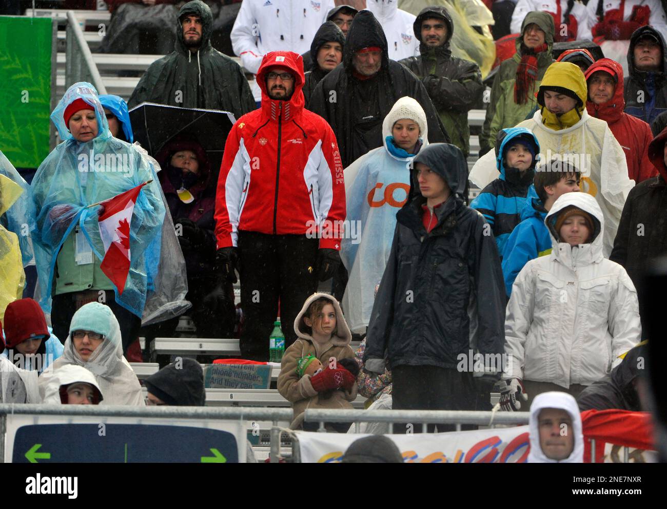 Spectators stand in the rain during the women's Parallel Giant Slalom ...