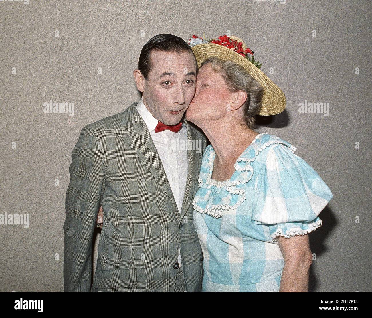 Pee Wee Herman gets a kiss from country star Minnie Pearl on Saturday, March 29, 1986 at the ...