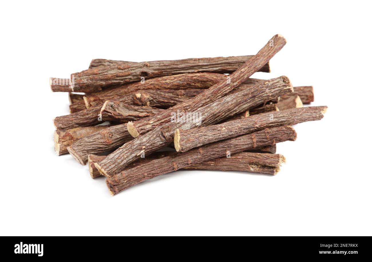 Dried sticks of liquorice root on white background Stock Photo - Alamy
