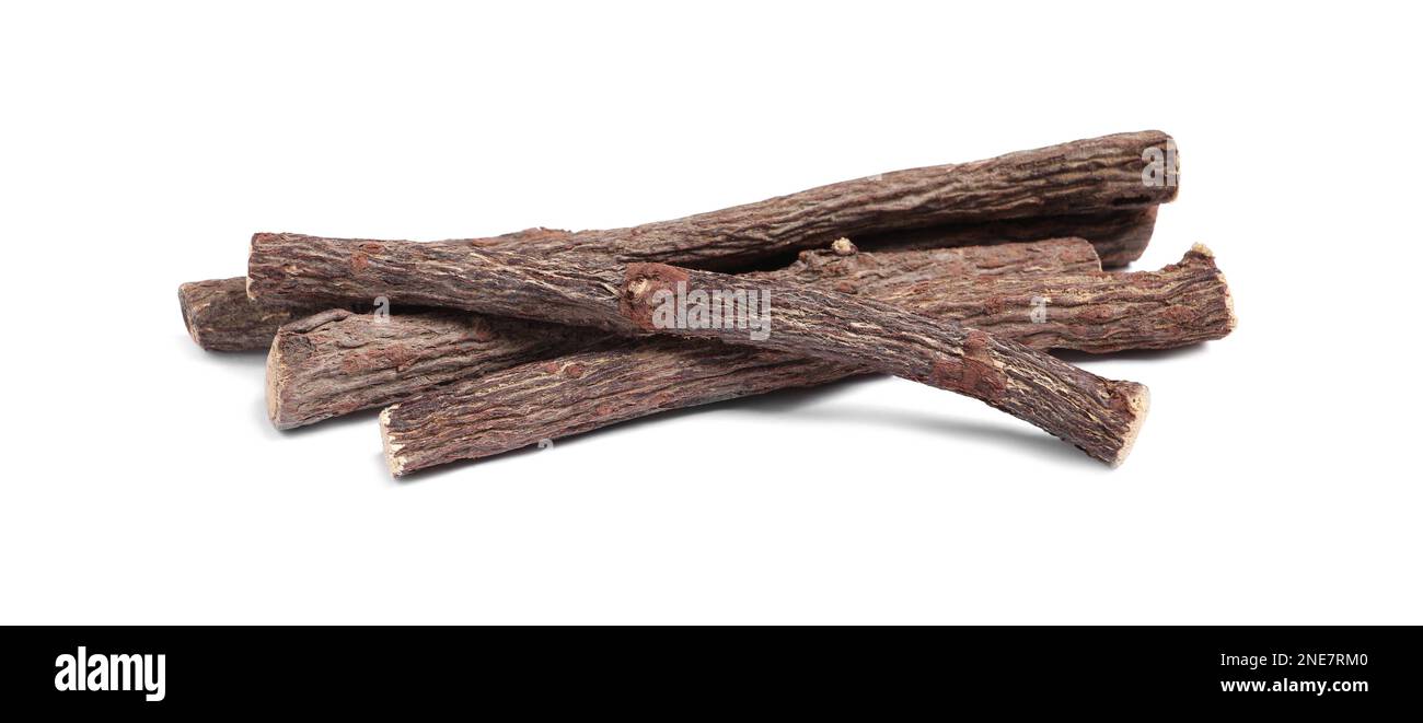 Dried sticks of liquorice root on white background Stock Photo - Alamy