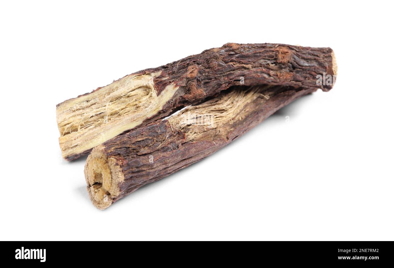 Dried sticks of liquorice root on white background Stock Photo - Alamy