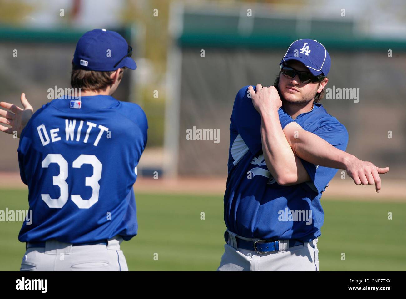 Los Angeles Dodgers' J.D. Closser, right, stretches with Blake DeWitt ...