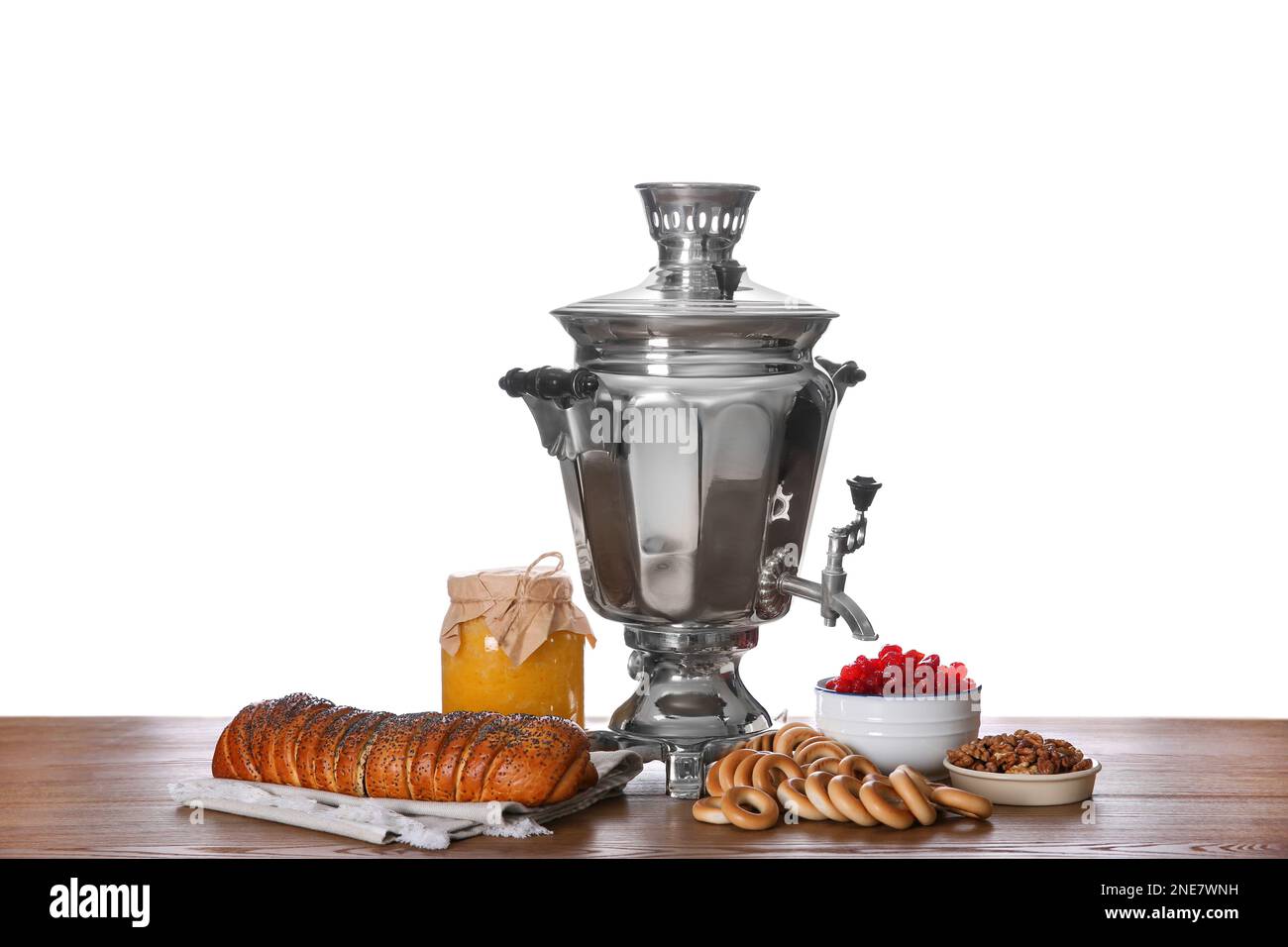 Traditional Russian samovar and treats on wooden table against white ...