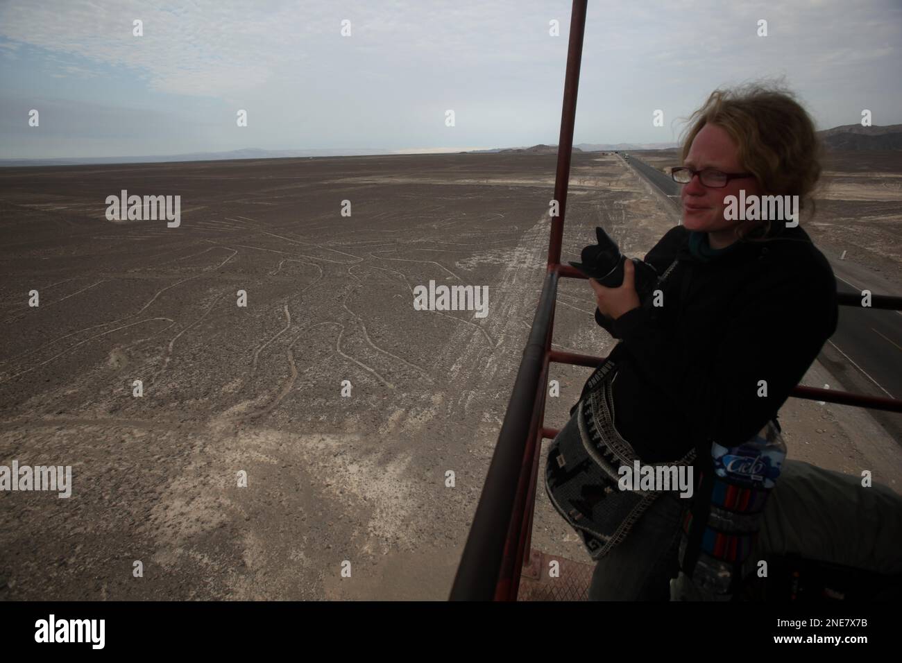 A tourist looks at the famed ancient geoglyphs known as the Nazca lines ...