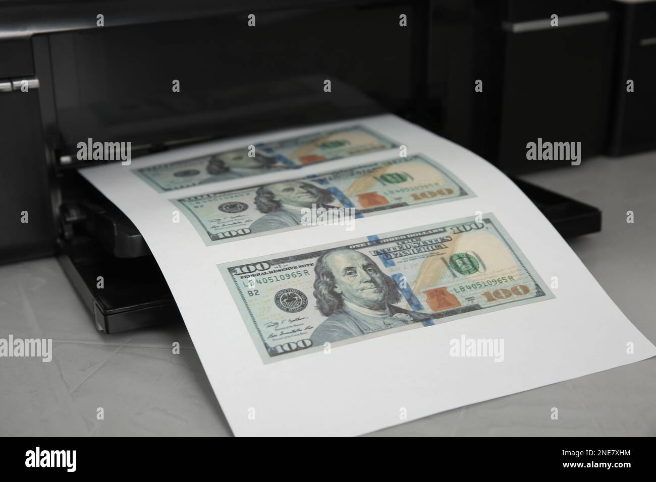 Printing dollar banknotes on grey table, closeup. Fake money concept ...