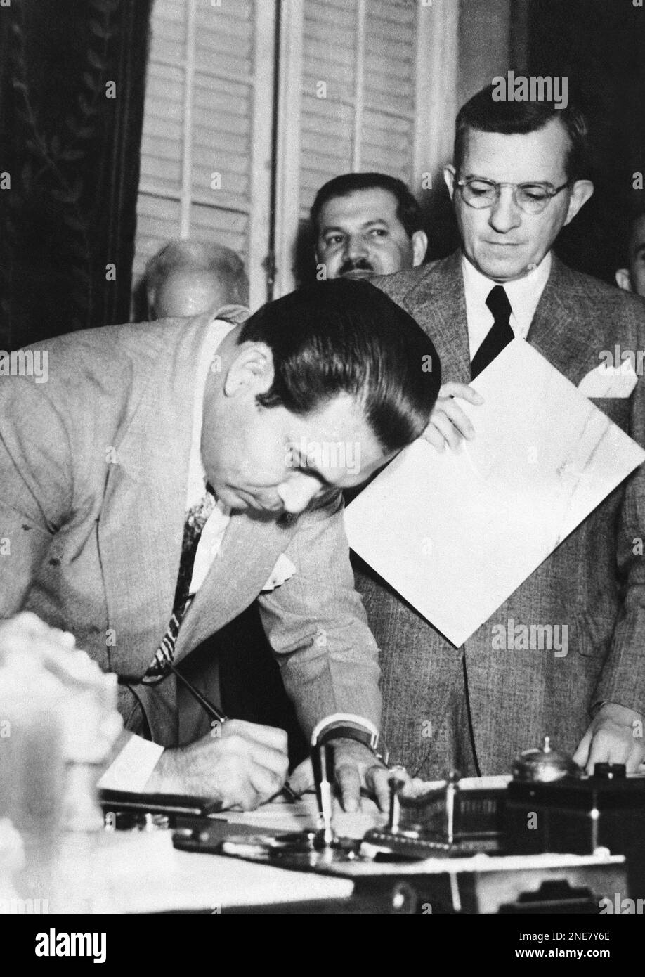 Cuban President Fulgencio Batista, signing a declaration of war against ...