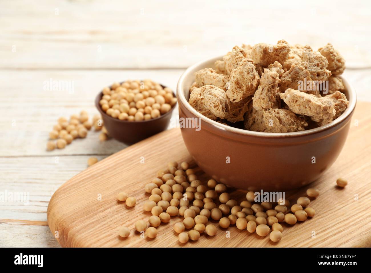 Dehydrated soy meat chunks and beans on white wooden table Stock Photo ...
