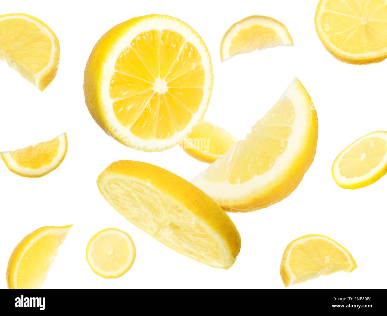 Fresh cut lemons flying on white background Stock Photo - Alamy