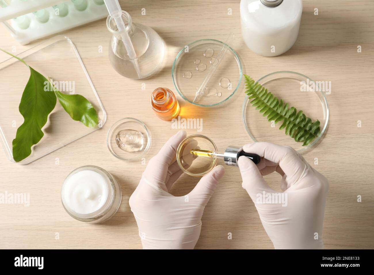 Scientist making cosmetic product at table, top view Stock Photo - Alamy
