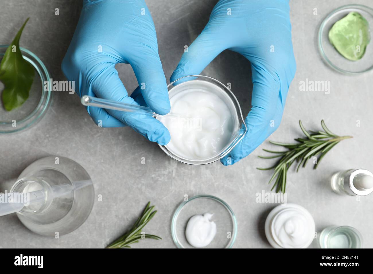 Scientist making cosmetic product at grey table, top view Stock Photo ...