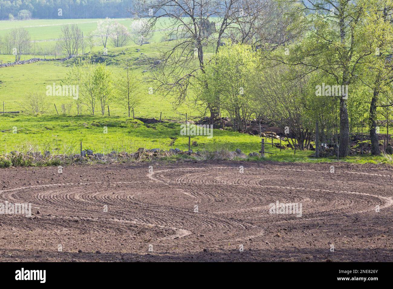 Harrowed field in countryside spring landscape Stock Photo - Alamy