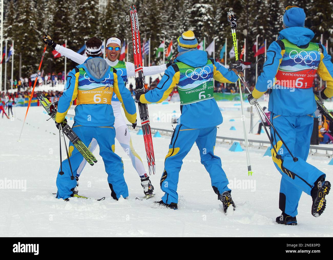 Sweden' Marcus Hellner is greeted by his teammates at the finish line ...