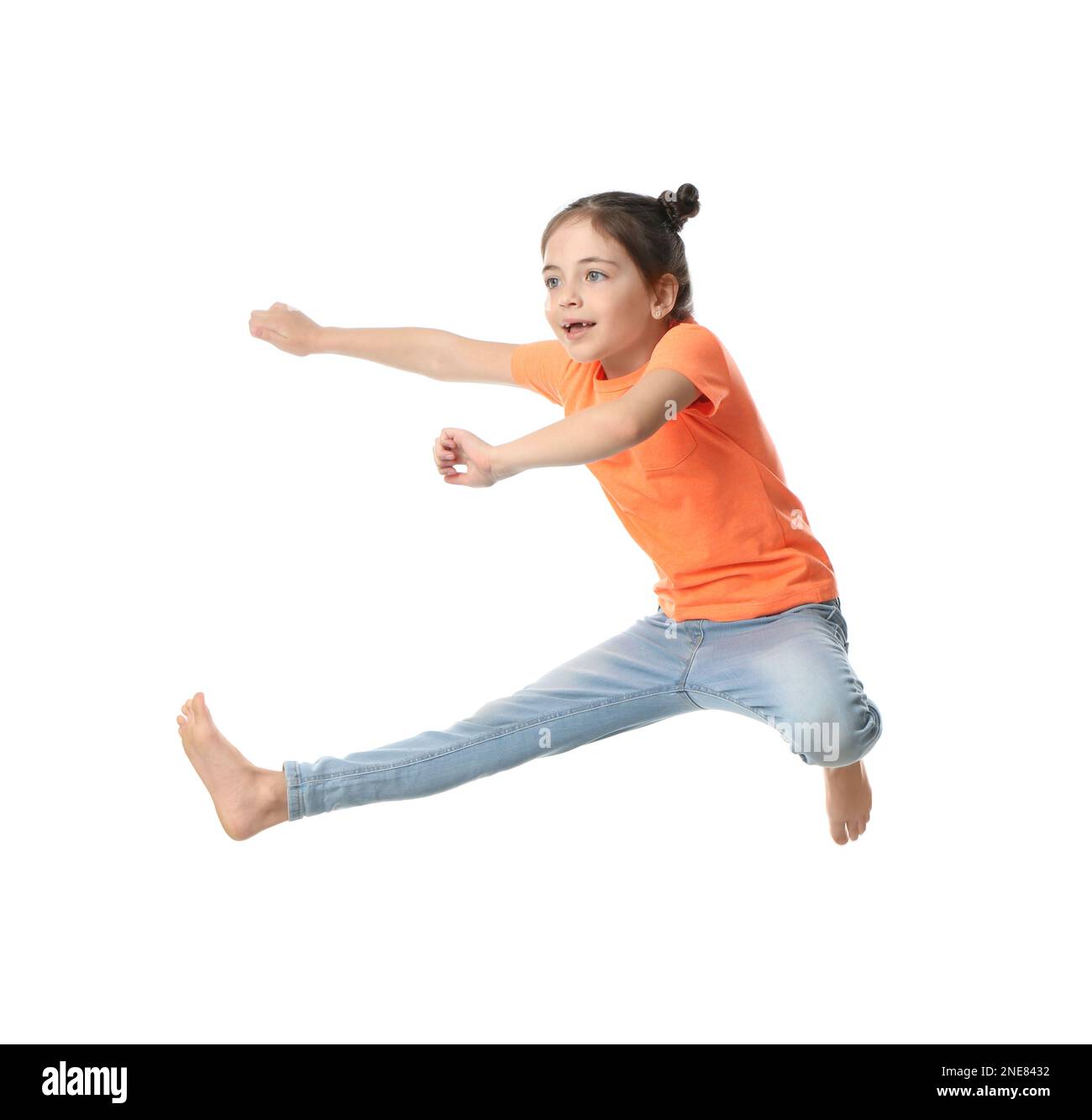 Cute little girl jumping on white background Stock Photo - Alamy