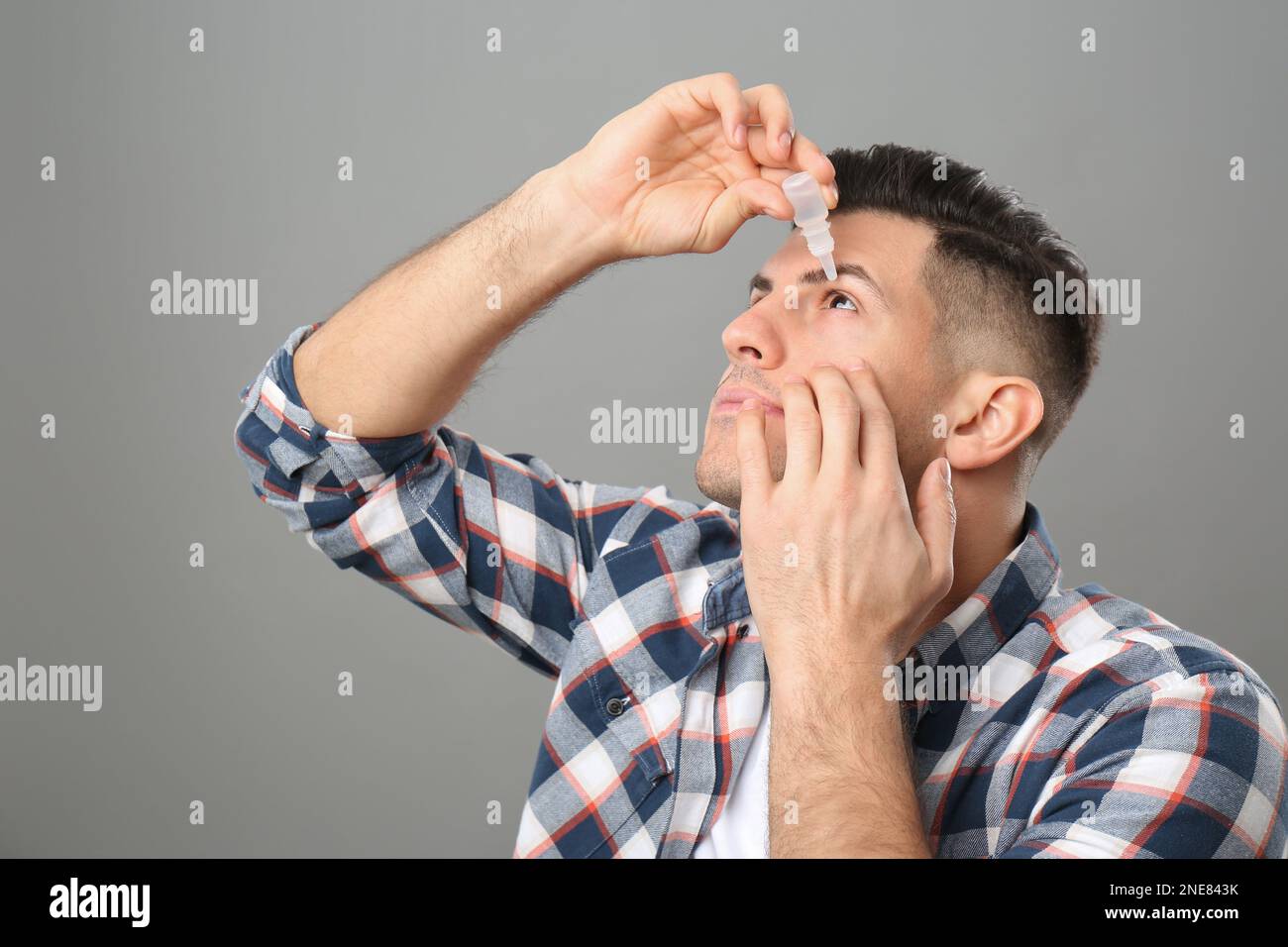 Man using eye drops hi-res stock photography and images - Alamy