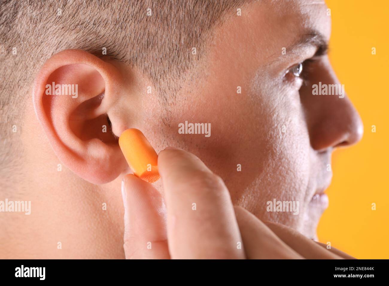 Yellow earplug ear hi-res stock photography and images - Alamy