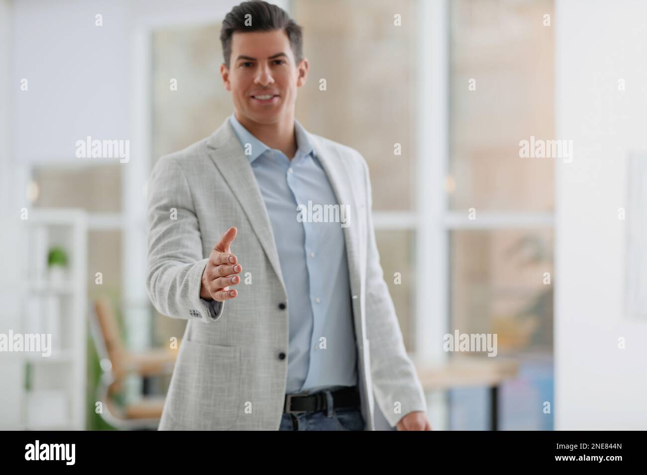 Businessman reaching out for handshake in office, focus on hand Stock ...