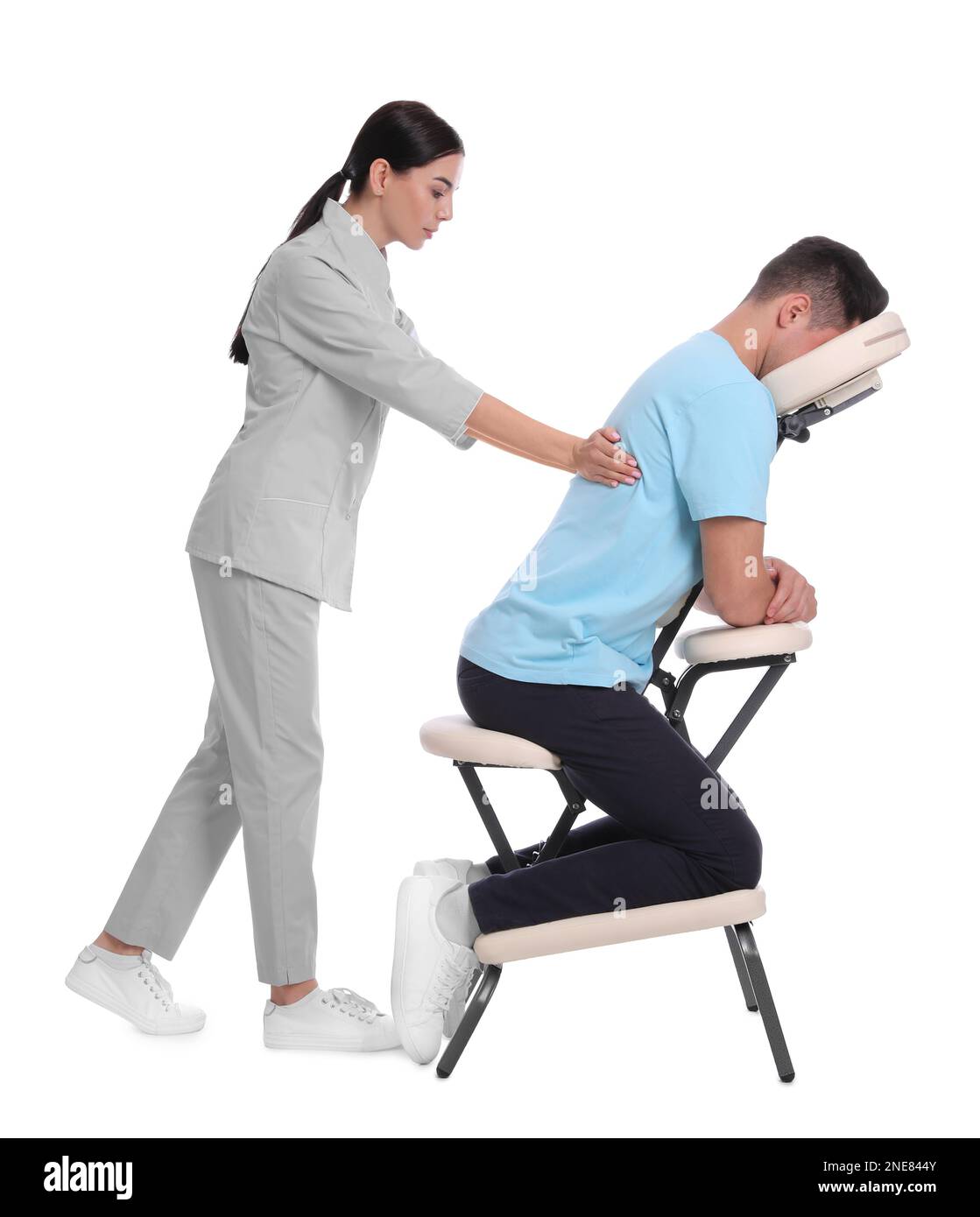 Man receiving massage in modern chair on white background Stock Photo ...