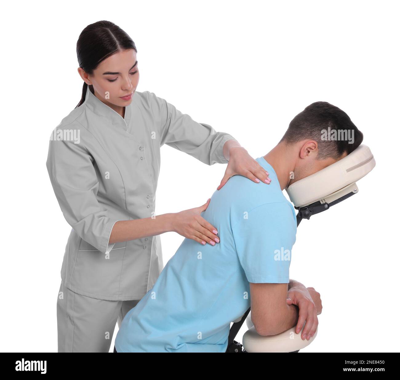 Man receiving massage in modern chair on white background Stock Photo ...