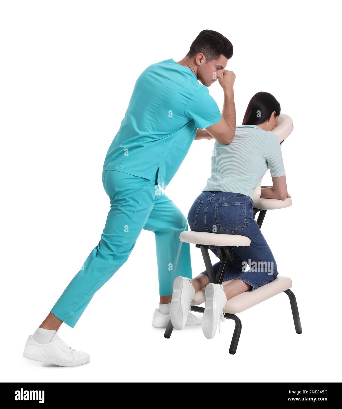 Woman receiving massage in modern chair on white background Stock Photo ...
