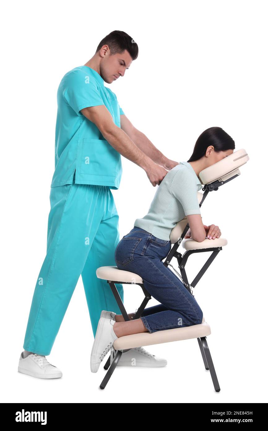 Woman receiving massage in modern chair on white background Stock Photo ...