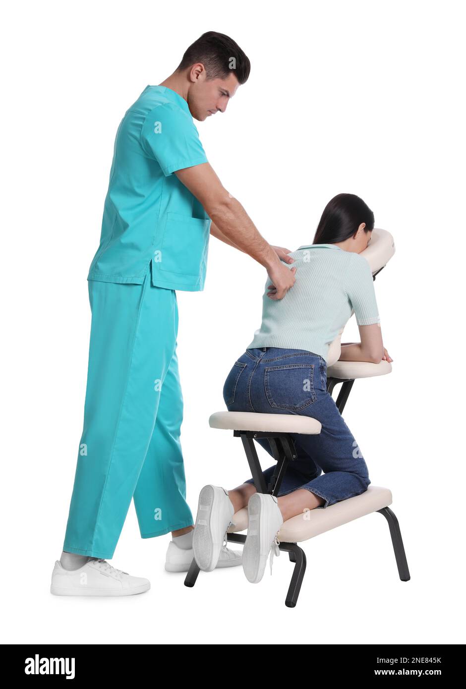Woman receiving massage in modern chair on white background Stock Photo ...