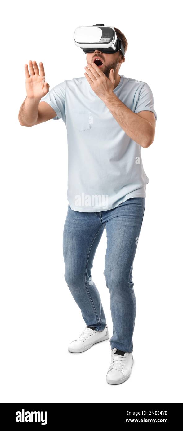 Emotional man using virtual reality headset on white background Stock ...