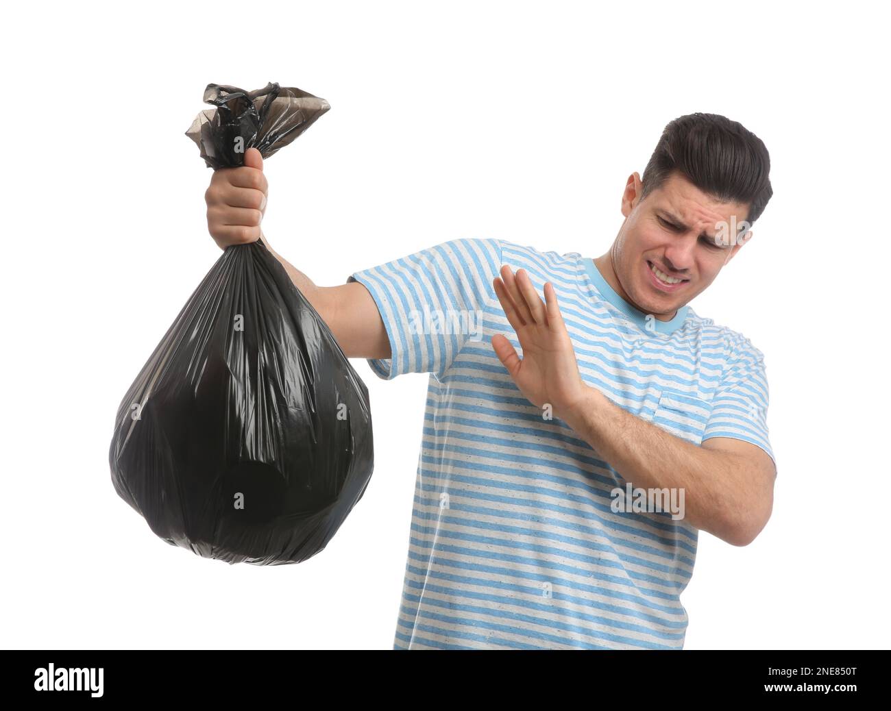 Man holding full garbage bag on white background Stock Photo - Alamy