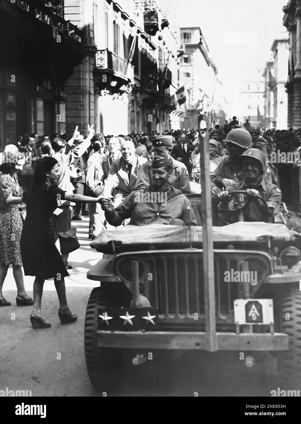 A girl steps from the crowd in a Rome Street on June 5, 1944 to place ...