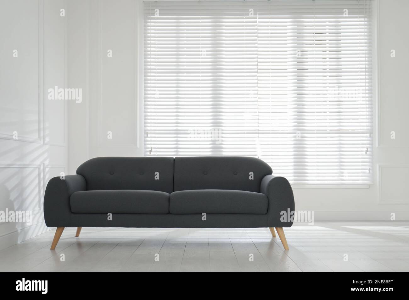Comfortable grey sofa near window indoors. Interior design Stock Photo ...
