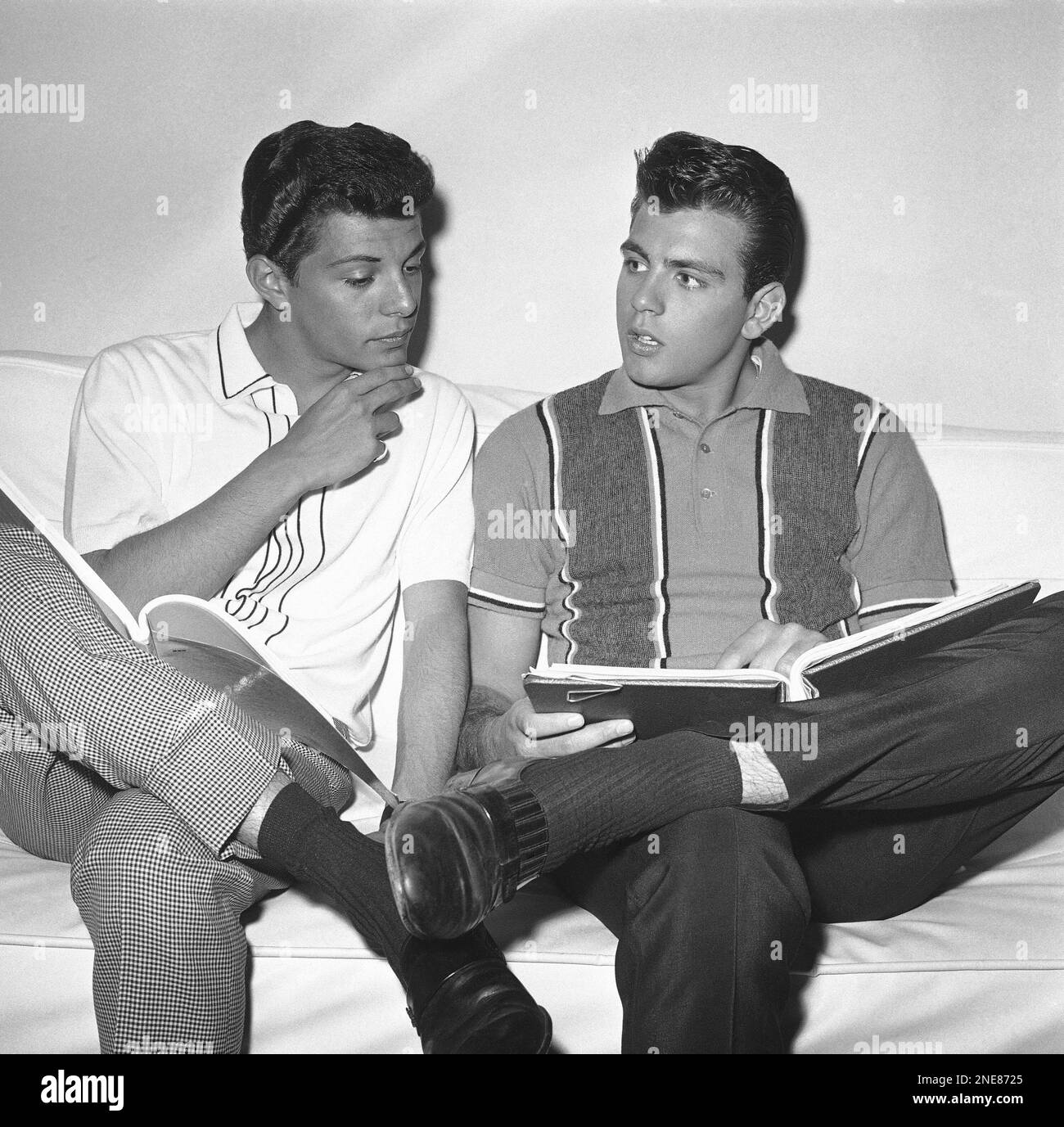 Frankie Avalon, left, looks over Fabian's shoulder to read, May 4, 1960 ...