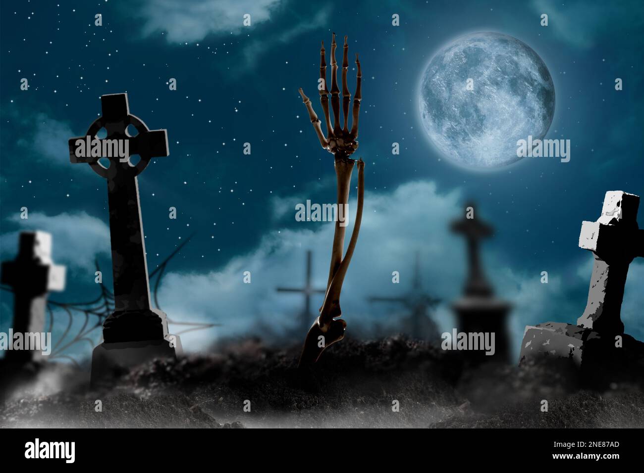 Scary skeleton rising out of grave at misty cemetery Stock Photo - Alamy