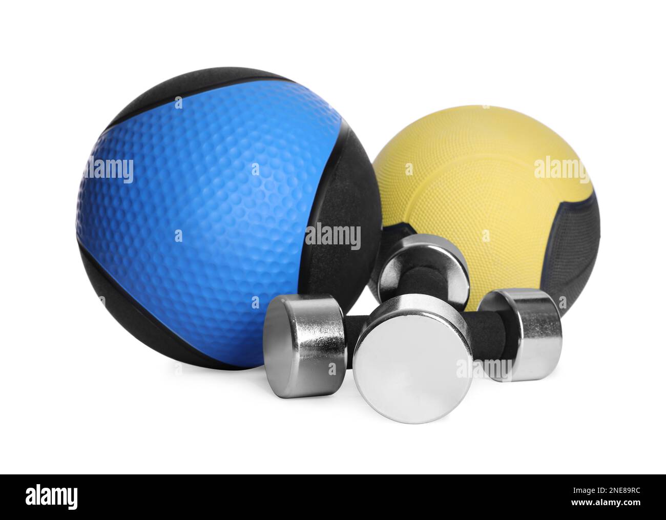 Medicine balls with dumbbells on white background Stock Photo - Alamy