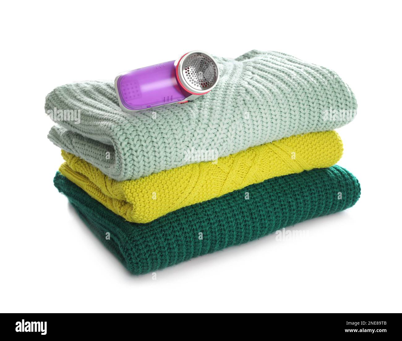 Modern fabric shaver and woolen clothes on white background Stock Photo ...