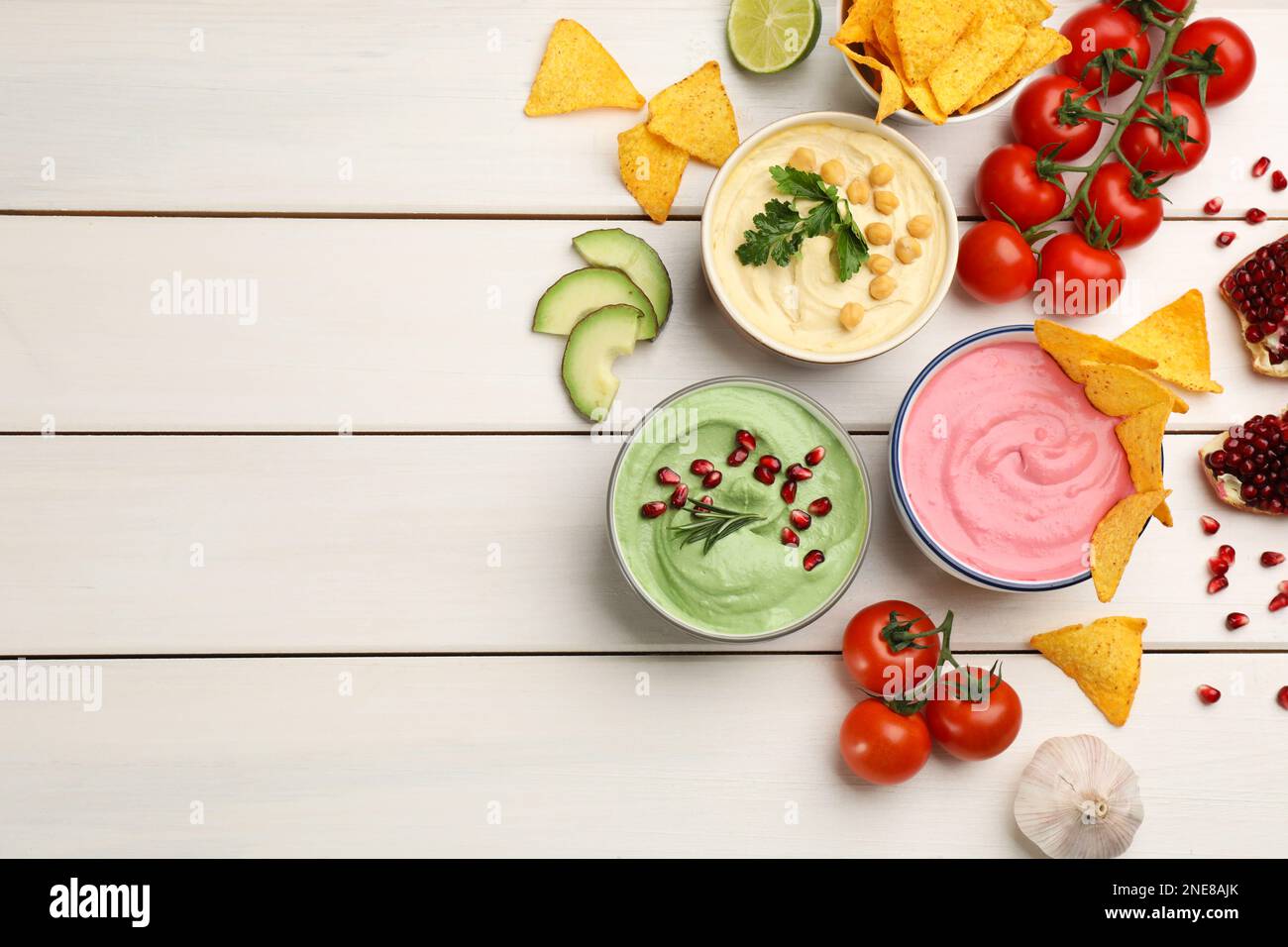 Flat lay composition with delicious hummuses on white wooden table ...