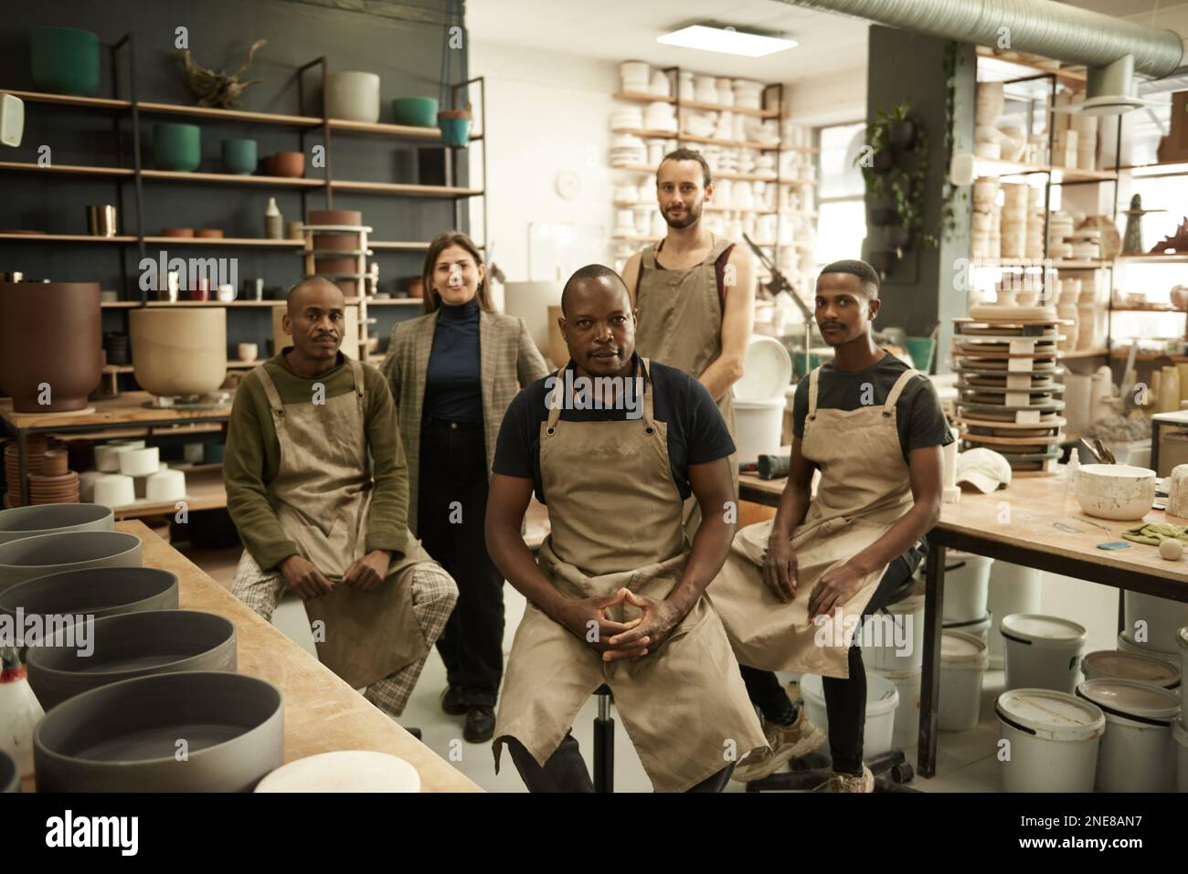 Group of diverse ceramists working in a pottery studio Stock Photo - Alamy