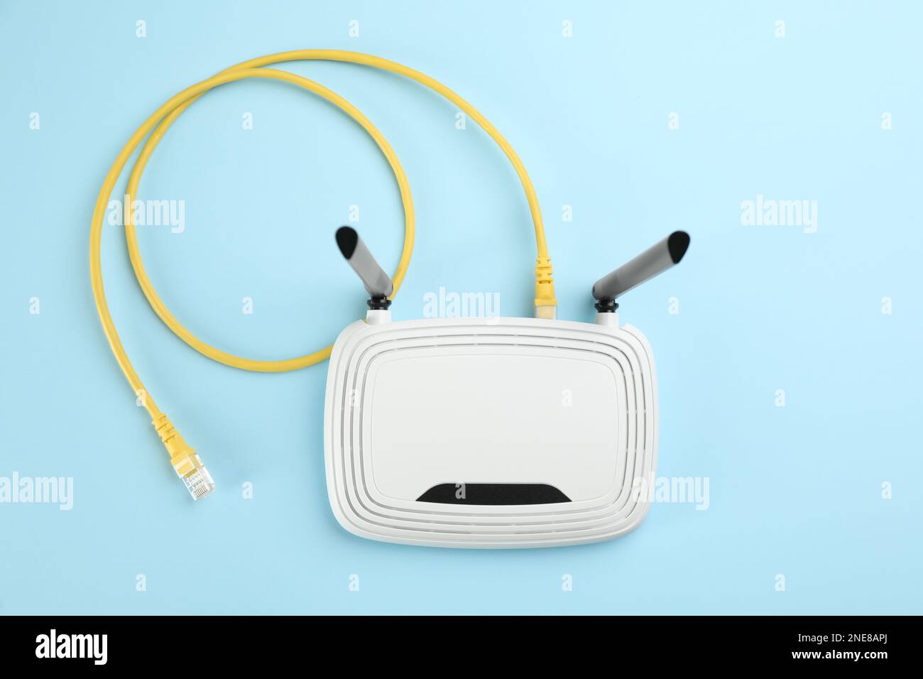 Modern Wi-Fi router on light blue background, top view Stock Photo - Alamy